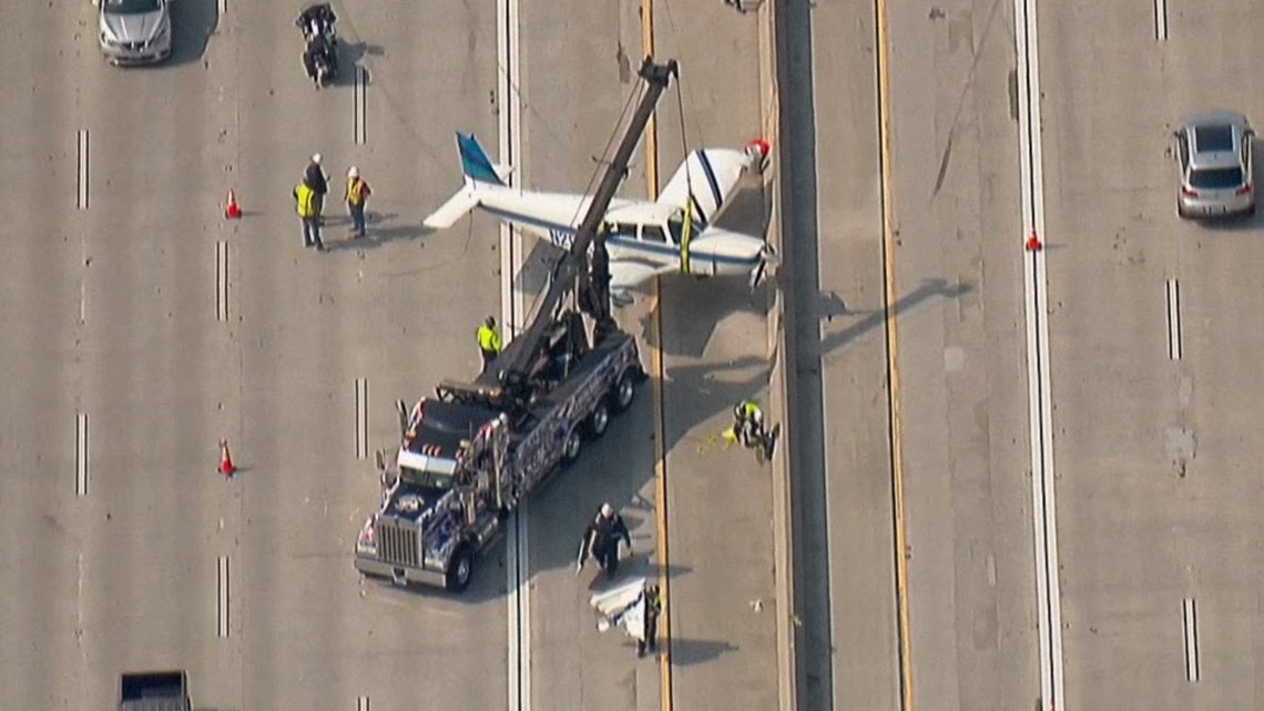 Plane that landed on freeway is removed by tow truck and flatbed truck ...