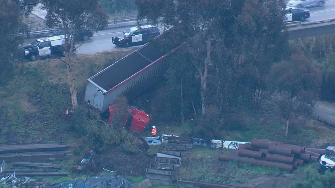 Big rig hits guardrail, veers down embankment off I-805 ramp | cbs8.com