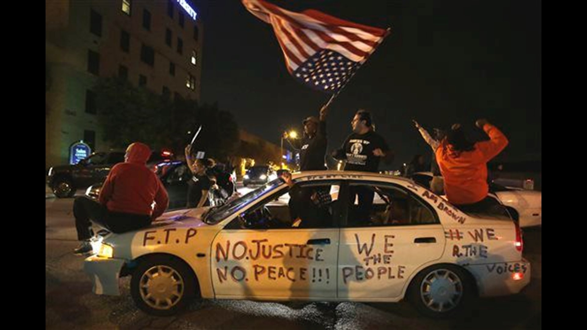 Angry protesters yell at riot police in St. Louis | cbs8.com