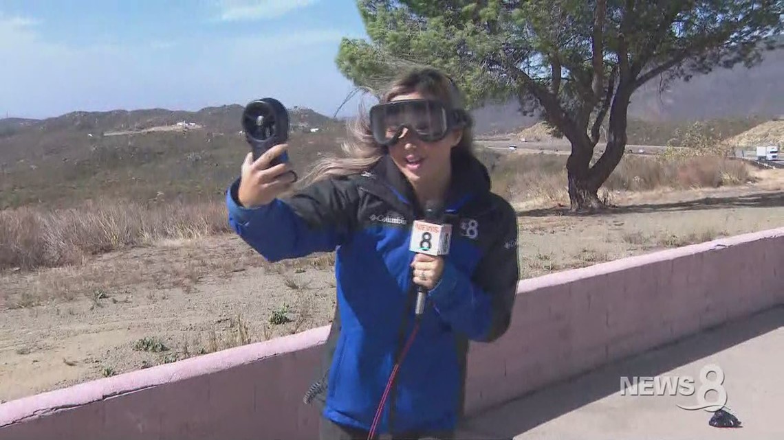 Kelly Hessedal shows winds speeds using anemometer | cbs8.com
