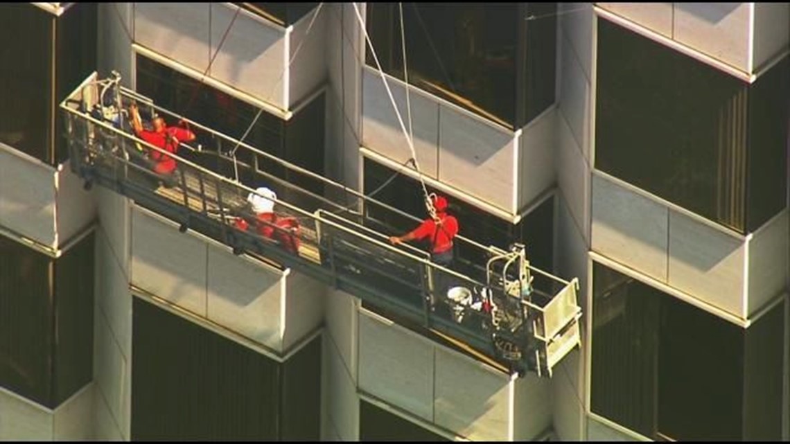 Window washers stuck on platform outside high rise | cbs8.com