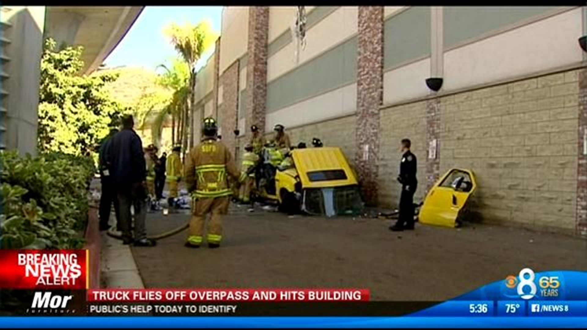 Truck flies off I-8 overpass, hits building | cbs8.com