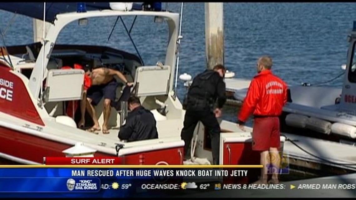 Man rescued after huge waves knock boat into jetty | cbs8.com