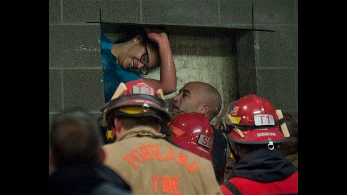 Rescuers free woman wedged between 2 buildings | cbs8.com
